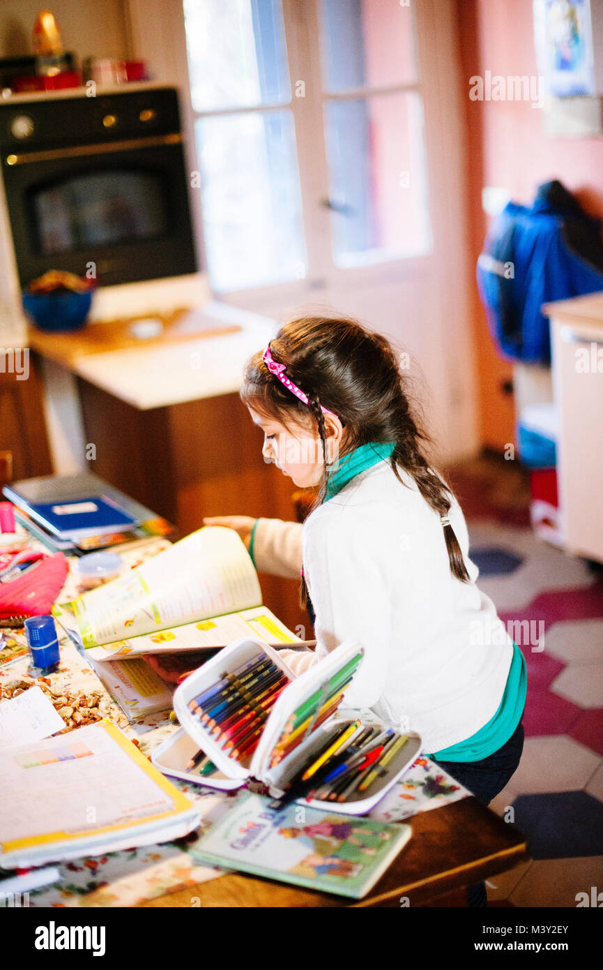 children sitting at the table at home perform school homework Stock ...