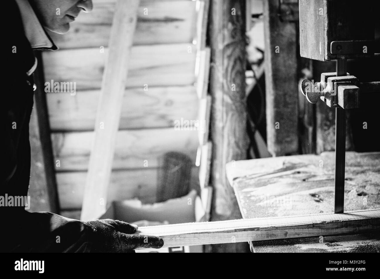 carpenter at work in his atelier works wood by creating objects Stock ...