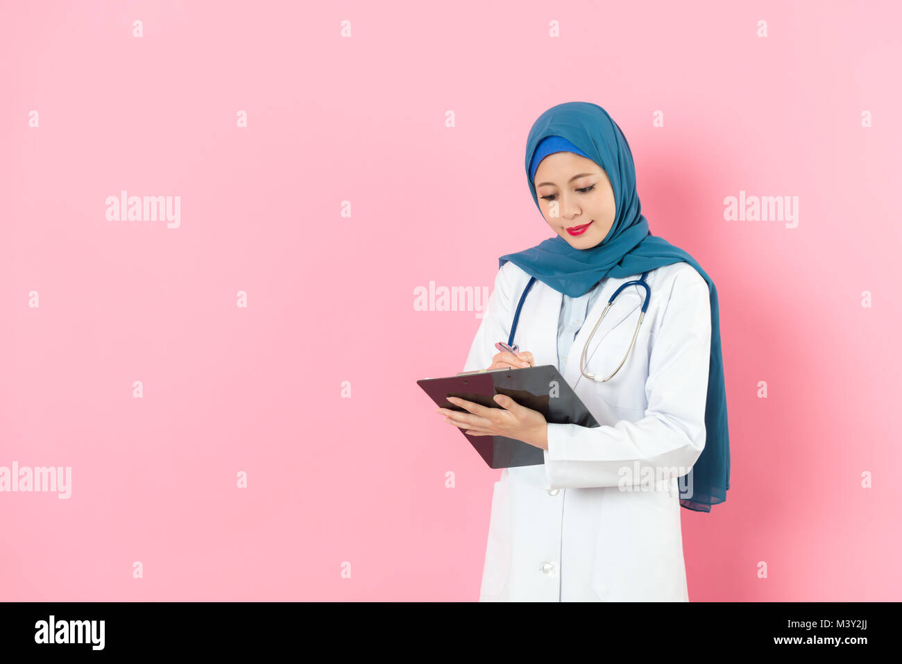 professional elegant woman muslim doctor writing patient medical record ...