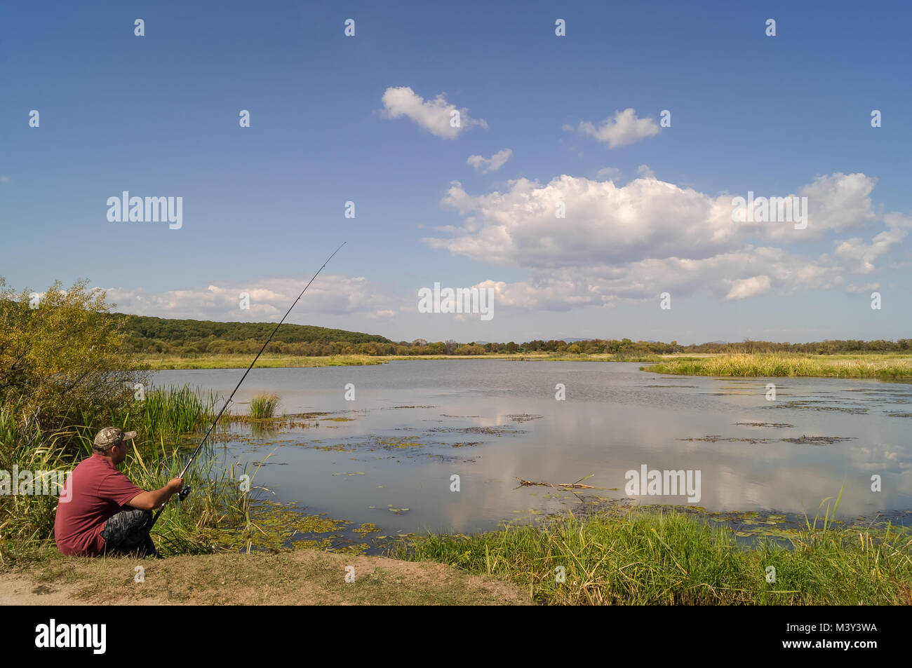 One fisherman catches fish in silence, enjoying the beautiful nature ...