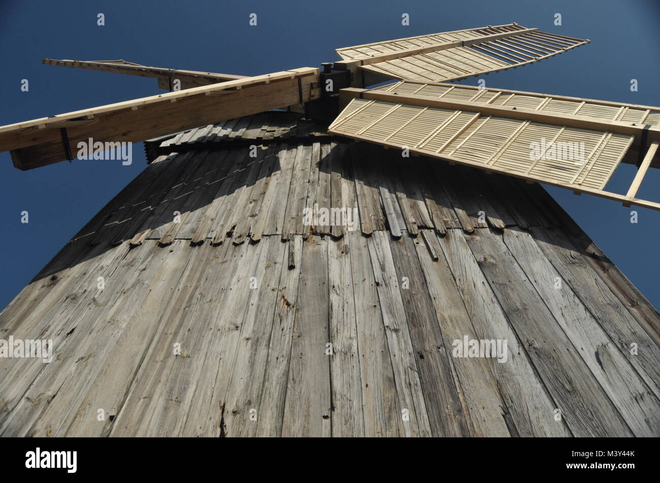 Wooden windmill. Monument. Antique mill powered by the wind Stock Photo ...