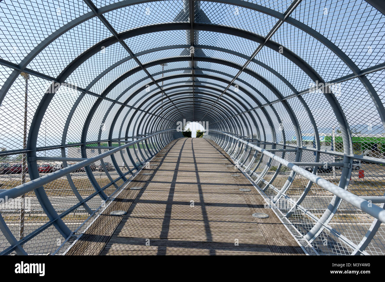 A footbridge over a road in Croatia in the form of a wire mess tunnel ...