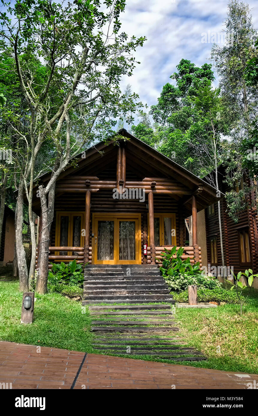Log house - Cozy log house amongst green environment Stock Photo - Alamy