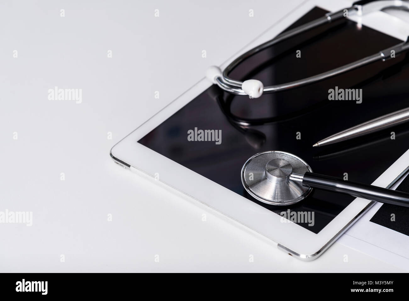 Health check concept. Medical tablet with stethoscope on white ...