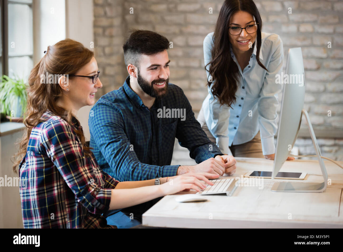 Picture of architects working together in office Stock Photo - Alamy