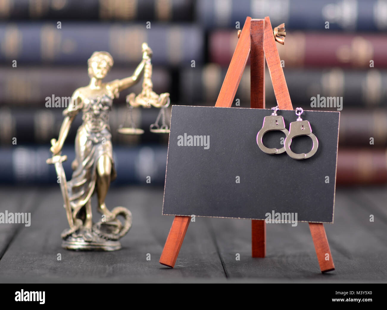 Blackboard, handcuffs, Lady Justice on the wooden background Stock ...