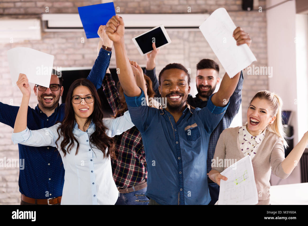 Group of successful young architects posing in office Stock Photo - Alamy