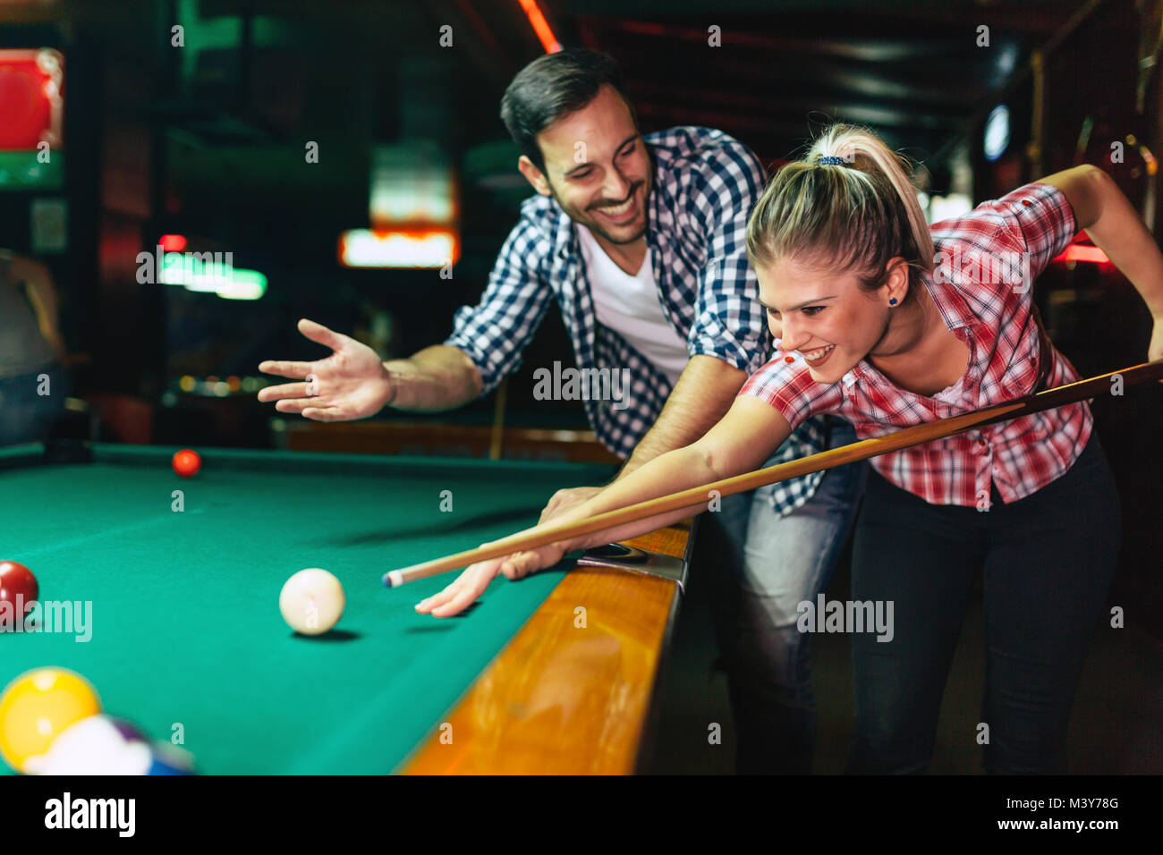 Young couple playing snooker together in bar Stock Photo - Alamy