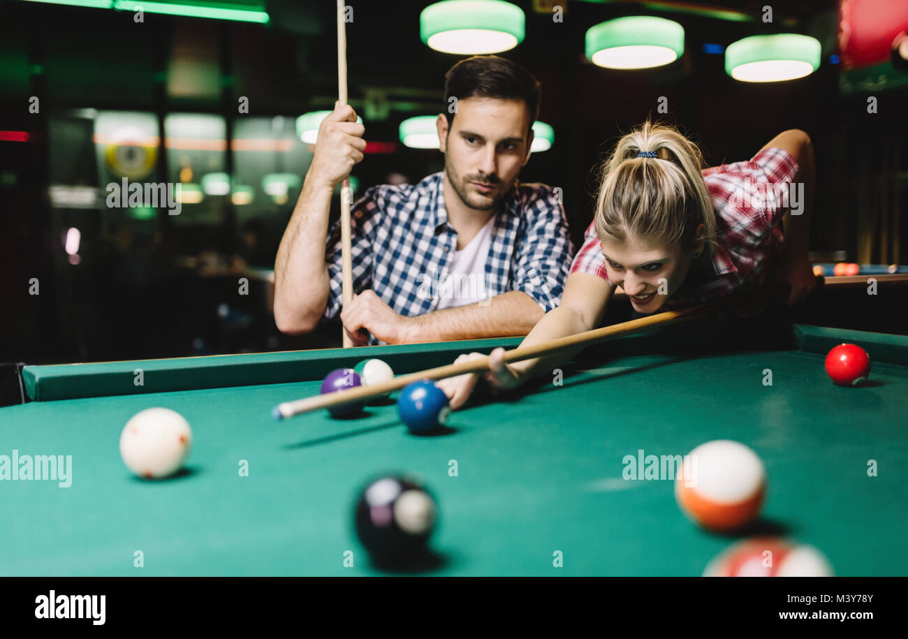 Young couple playing snooker together in bar Stock Photo - Alamy