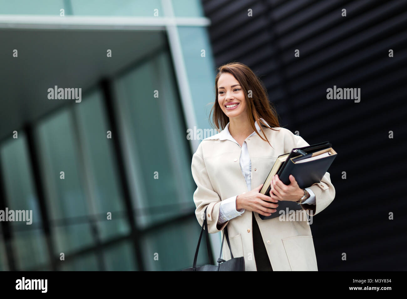 Portrait of young businesswoman going to office Stock Photo - Alamy
