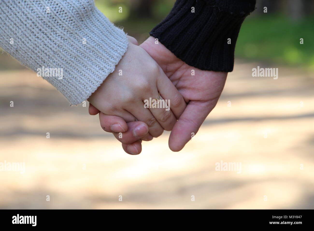 closeup of loving couple holding hands Stock Photo - Alamy