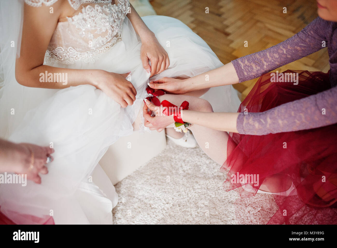 Bridesmaids helping bride to get ready for her wedding ceremony Stock ...