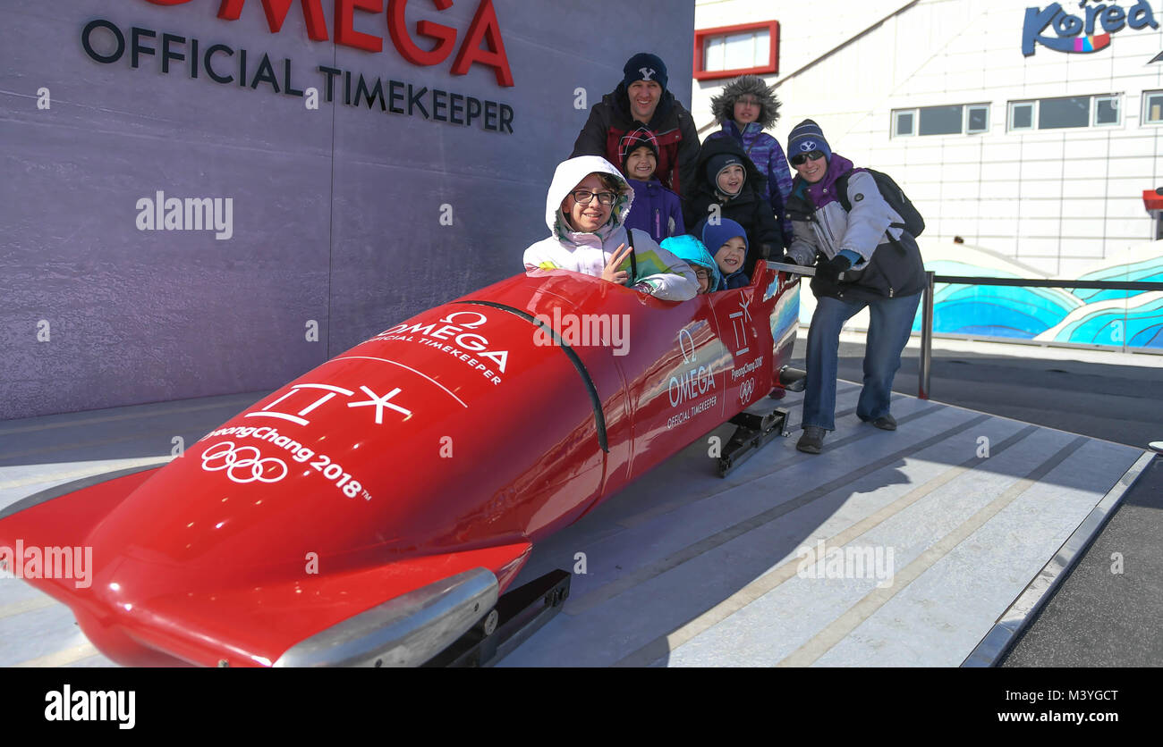 Pyeongchang, South Korea. 13th Feb, 2018. Visitors pose for photos with ...