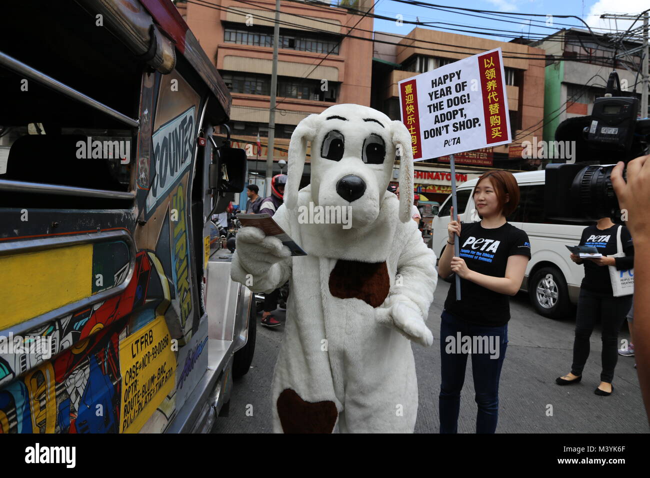 Manila. 12th Feb, 2018. A six-foot-tall dog mascot distributes leaflets ...