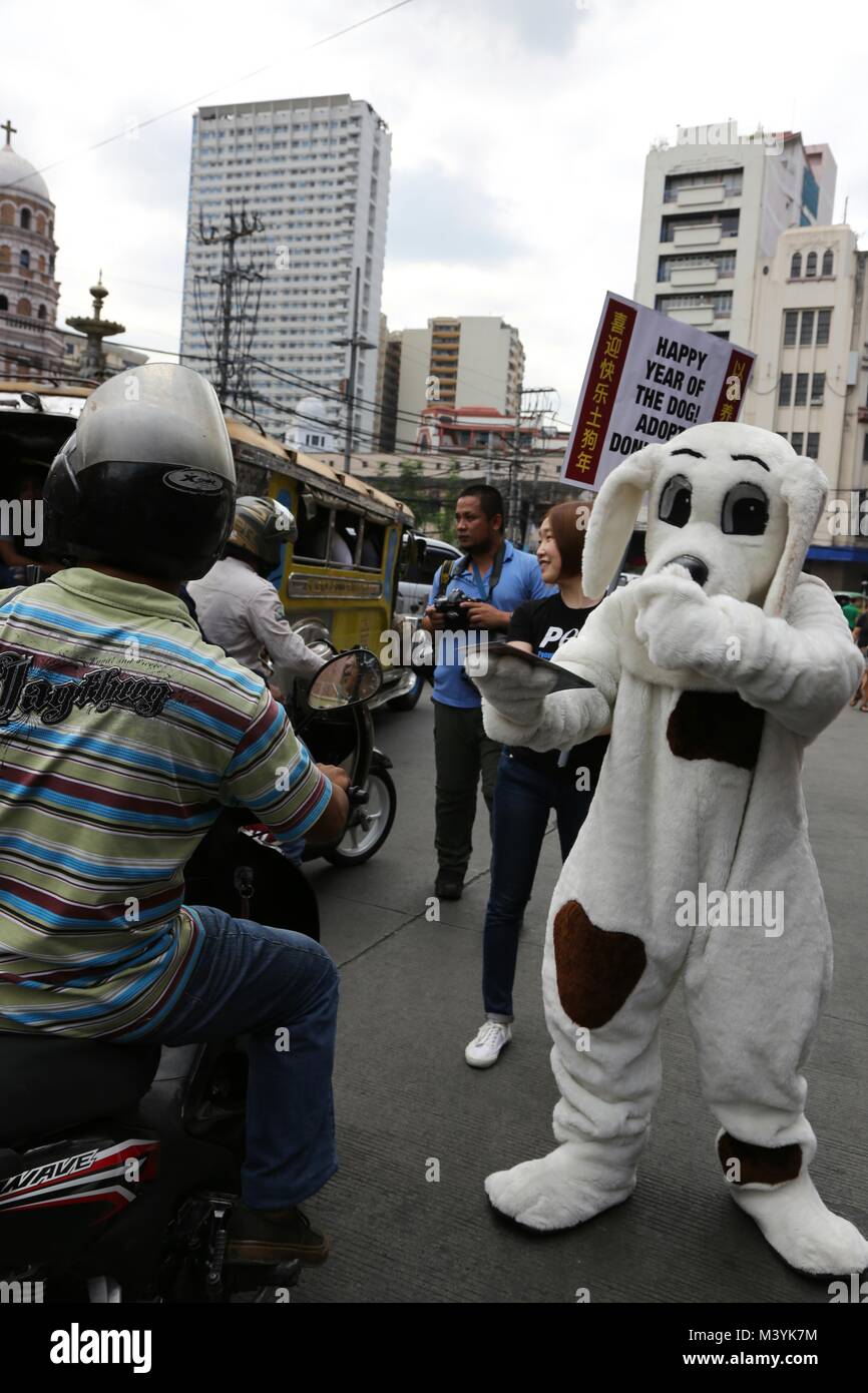 Manila. 12th Feb, 2018. A six-foot-tall dog mascot distributes leaflets ...