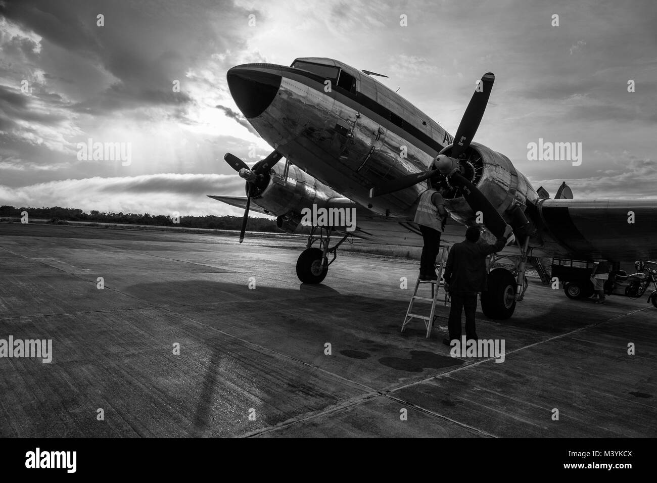 Colombian mechanics repair a propeller-driven engine of a Douglas DC-3 ...