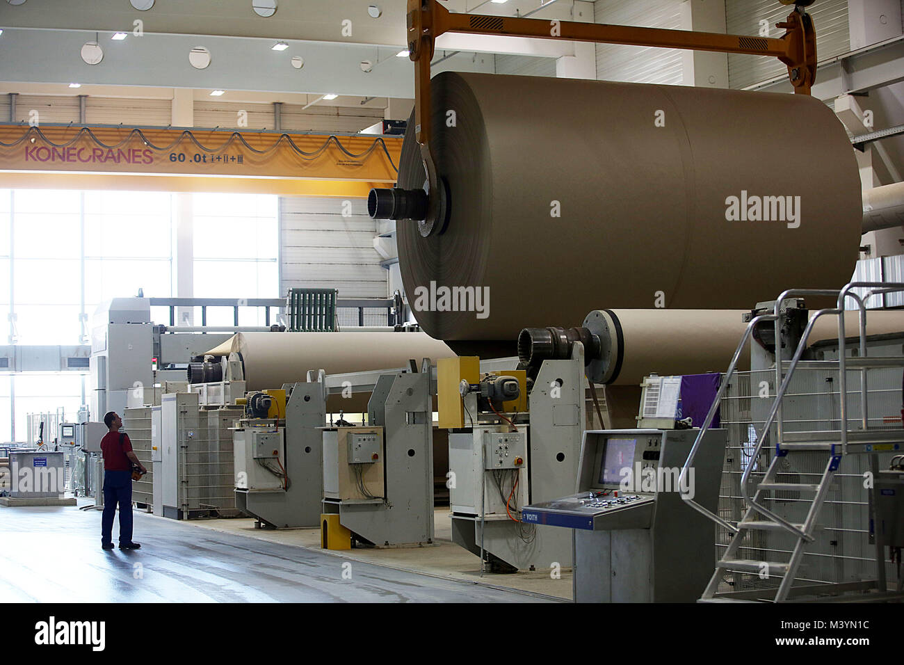 Dueren, Germany. 13th Feb, 2018. A worker transports rolls of ...