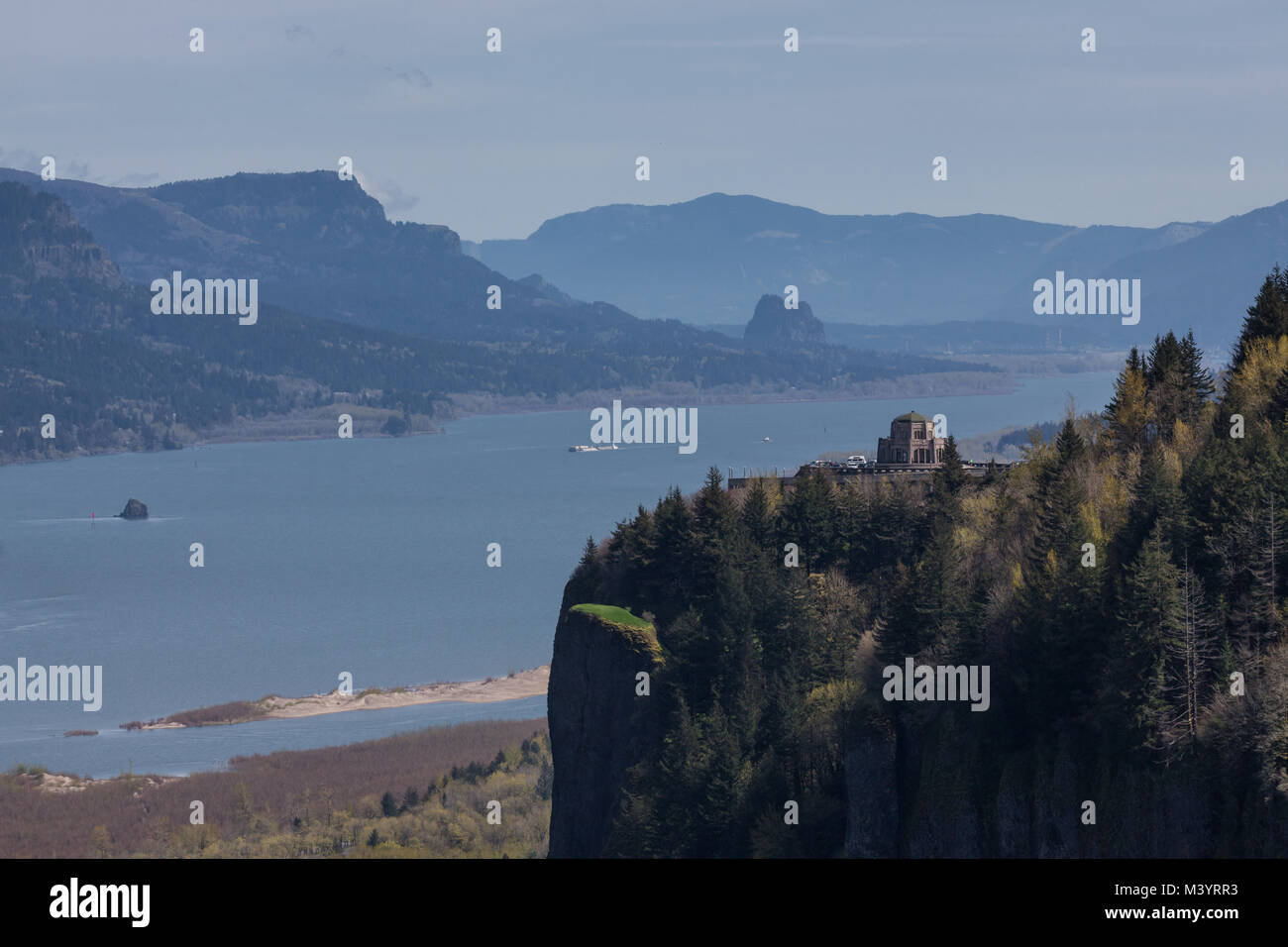 A view of the Columbia River Gorge with the Vista House on a ledge ...