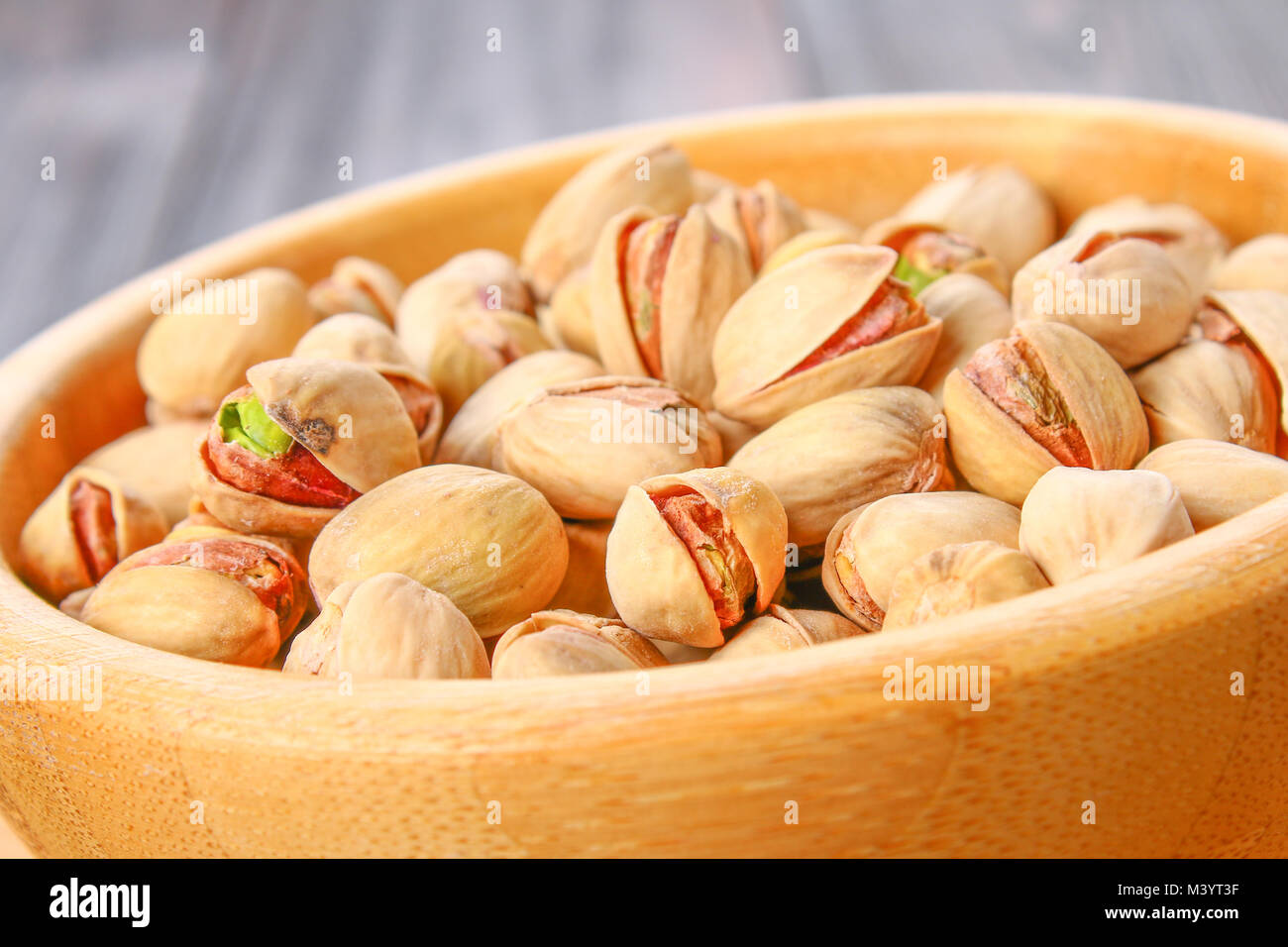 Dish full of pistachios with more pistachios on side Stock Photo - Alamy