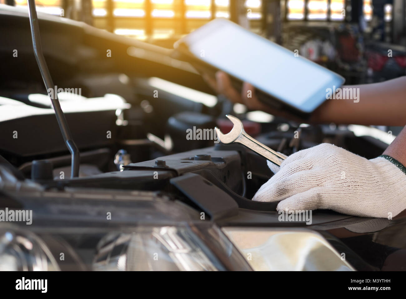Mechanic repairing a car in garage Auto repair car engine, close u ...