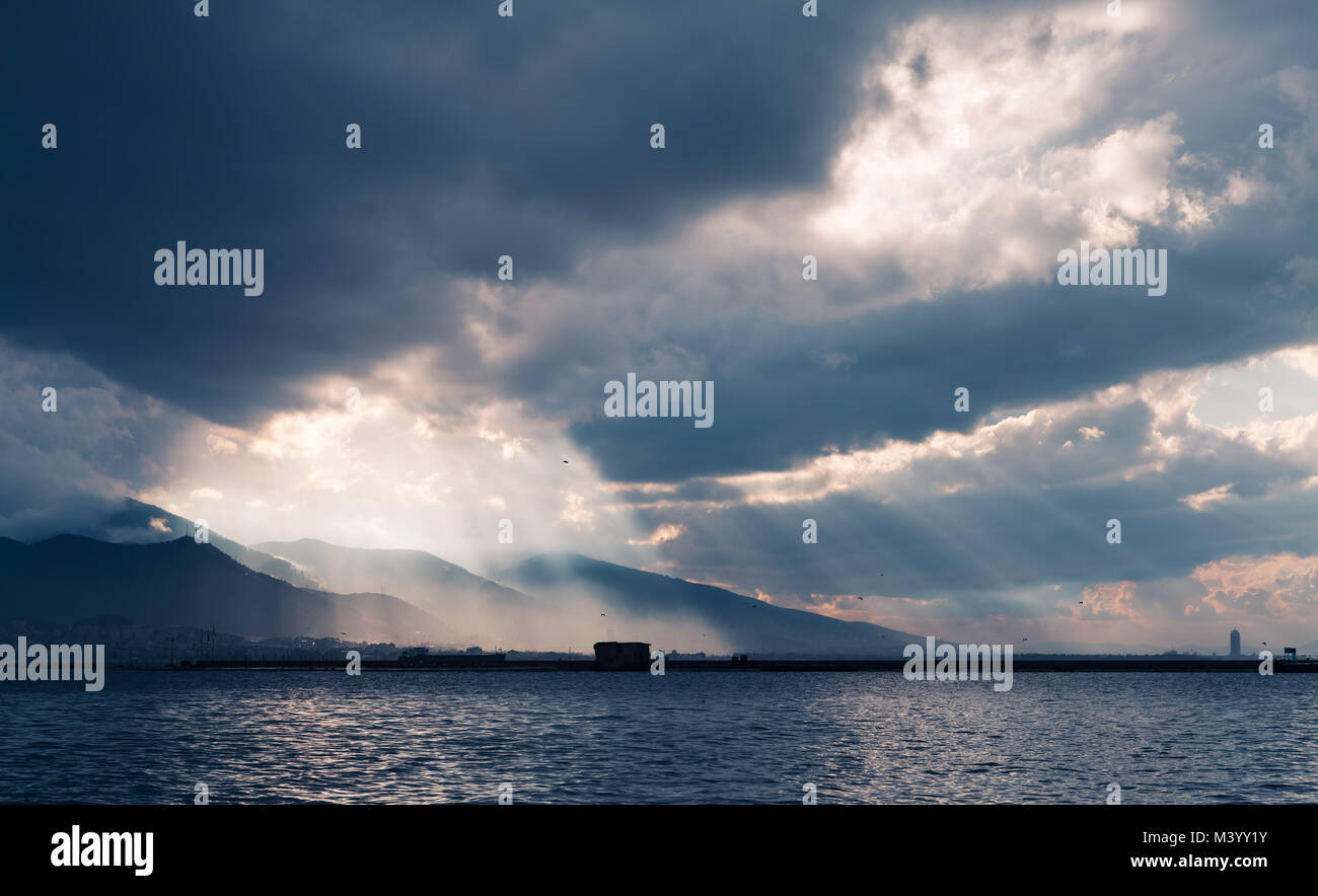 Dark stormy clouds with sunbeams, landscape background photo, bay of ...