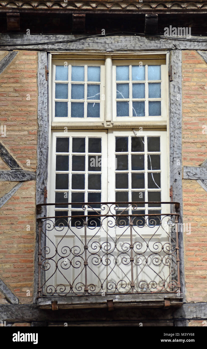 French window leading to an upper story balcony in a traditional half ...