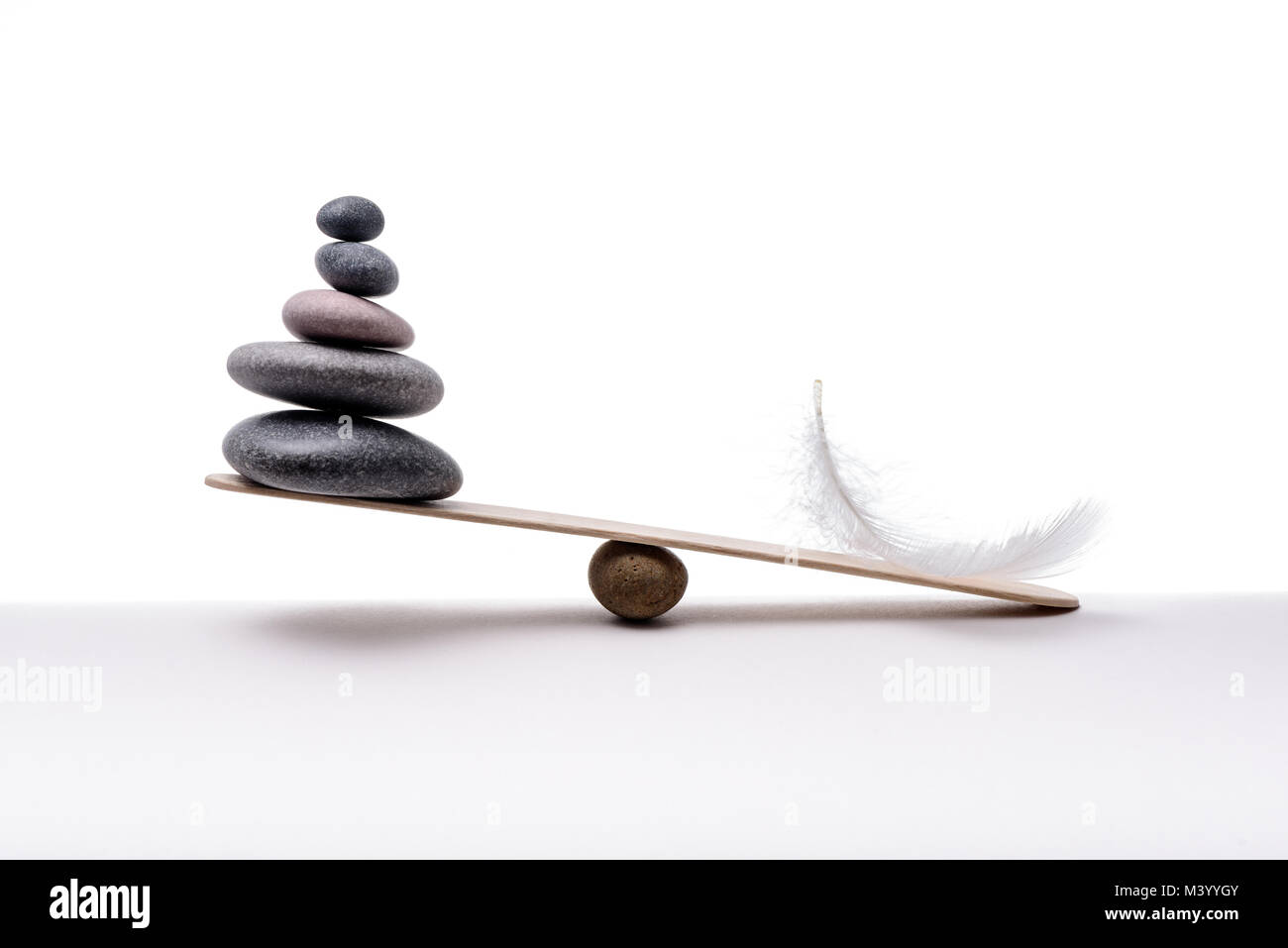 Stone balance with plume. Concept of heavy and light Stock Photo - Alamy