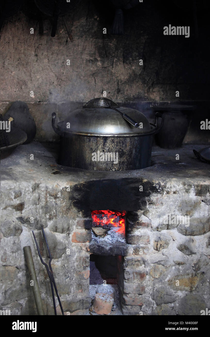 An old stone stove with an old saucepan. China Stock Photo - Alamy