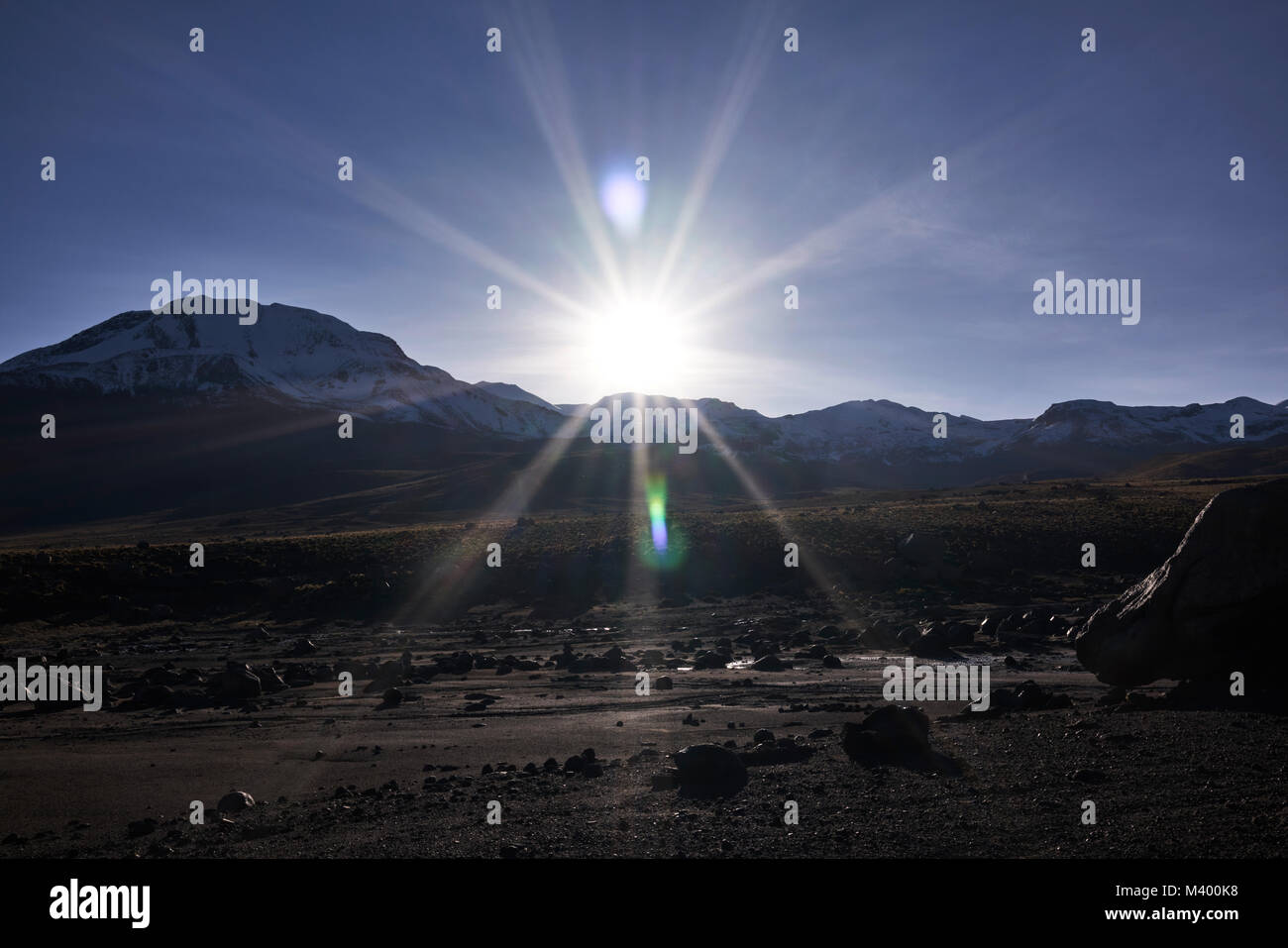 Sun rising over the Andes Mountains and the El Tatio geyser filed below ...