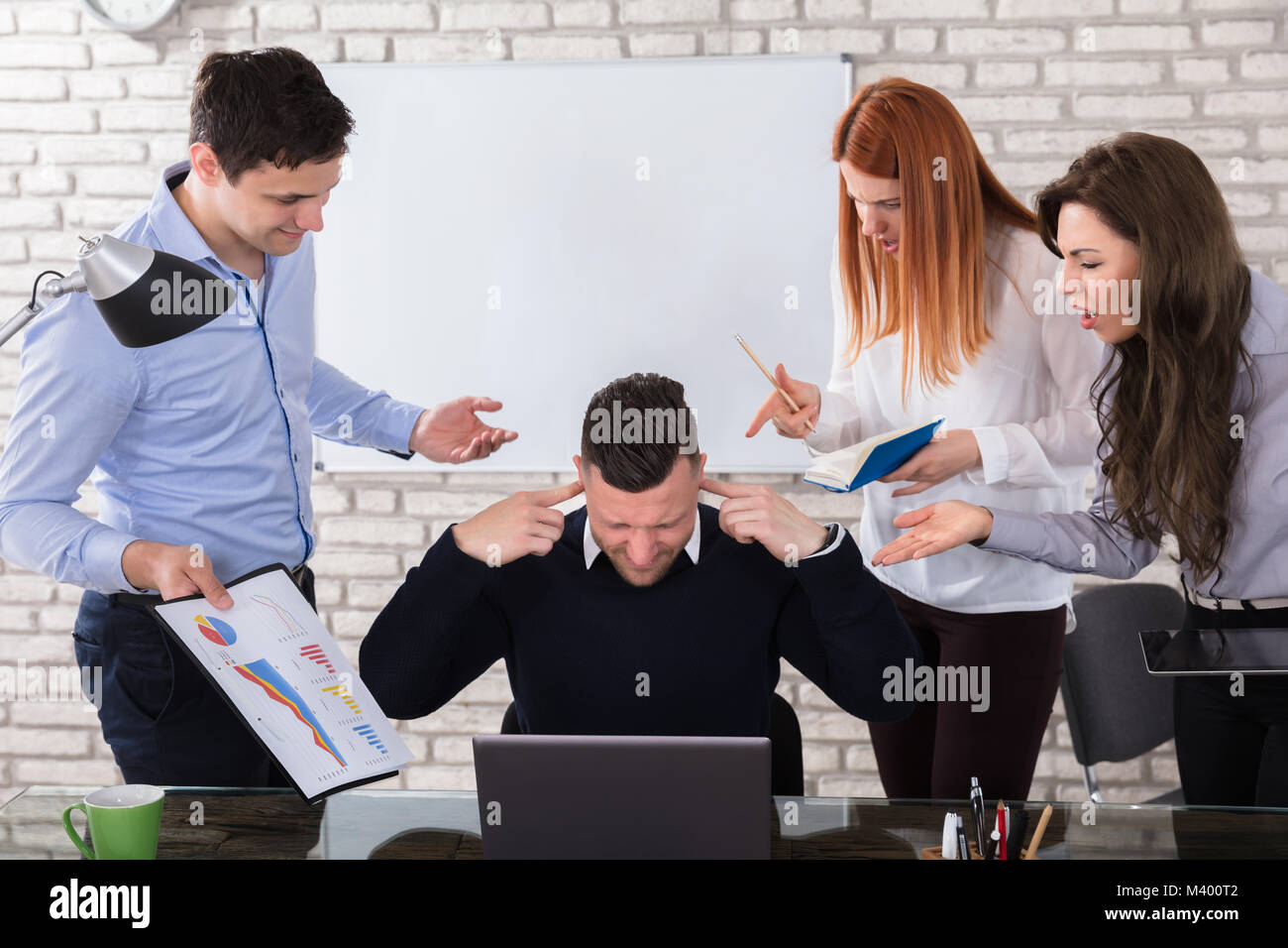 Angry Business People Pointing At Male Colleague During Meeting In ...