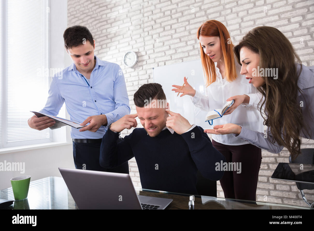 Angry Business People Pointing At Male Colleague During Meeting In ...