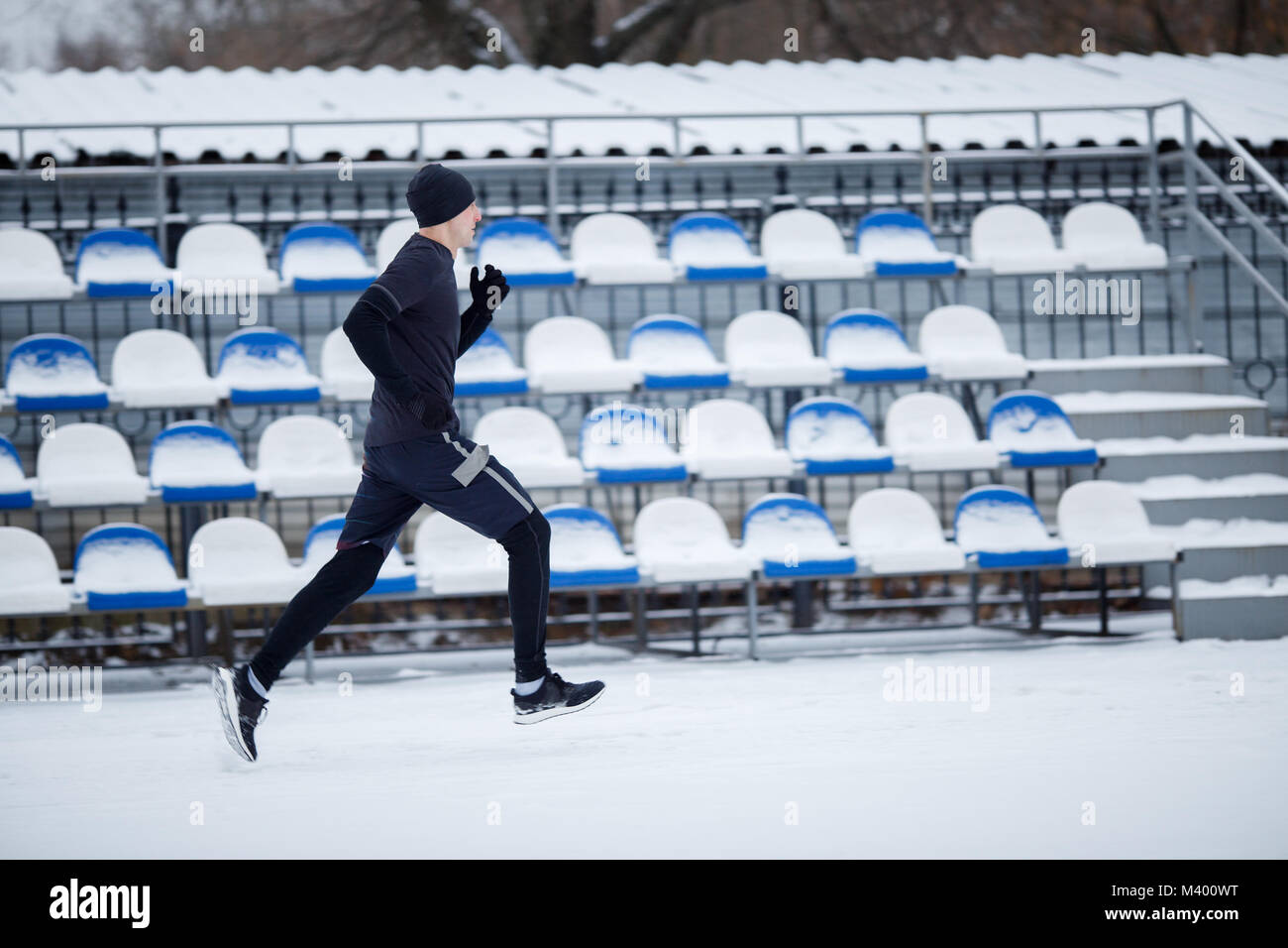 Image of running man in sports clothes on stadium Stock Photo - Alamy