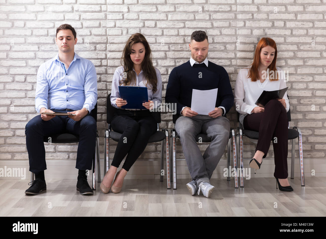 Group Of People Sitting On Chair Waiting For Job Interview In Office ...