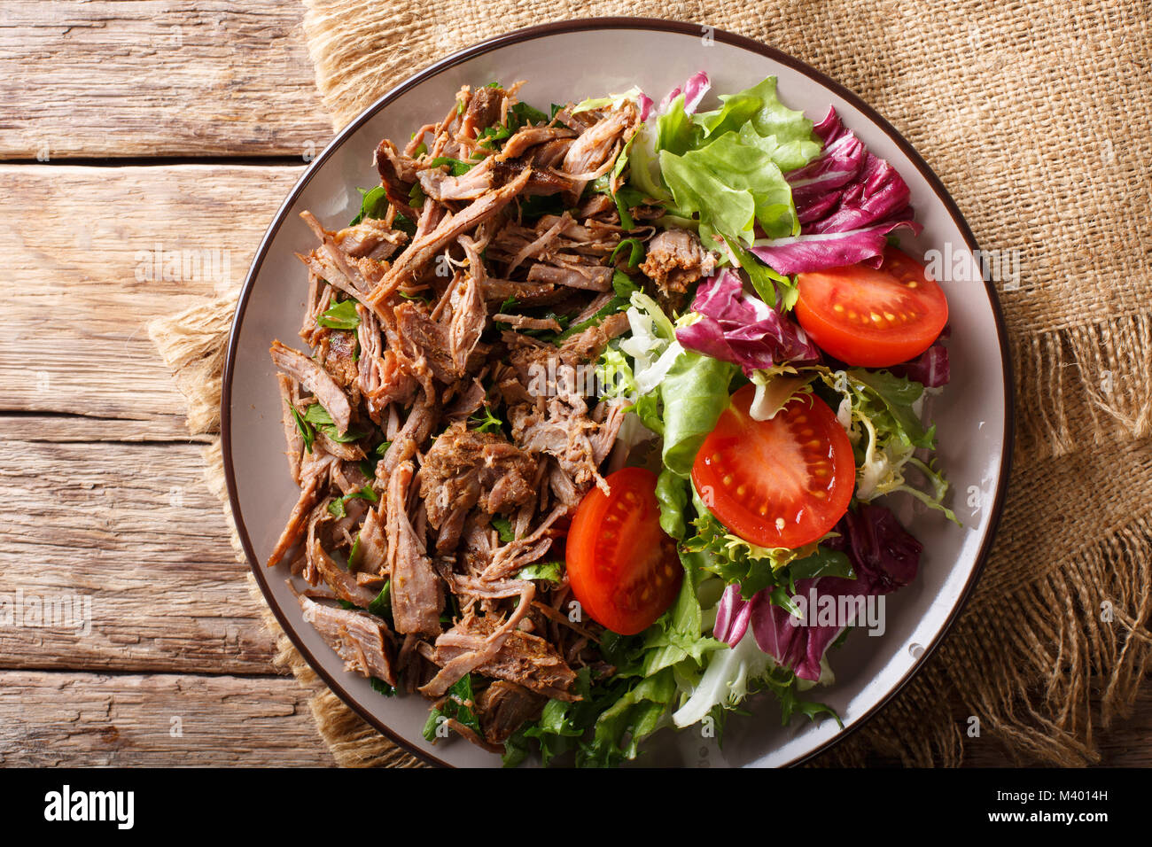 Healthy lunch: tender pulled beef with vegetable salad close-up on a ...