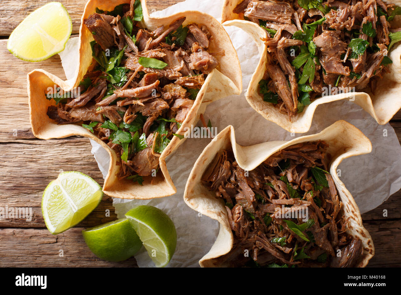 Mexican barbacoa tacos with spicy pulled beef close-up on the table ...