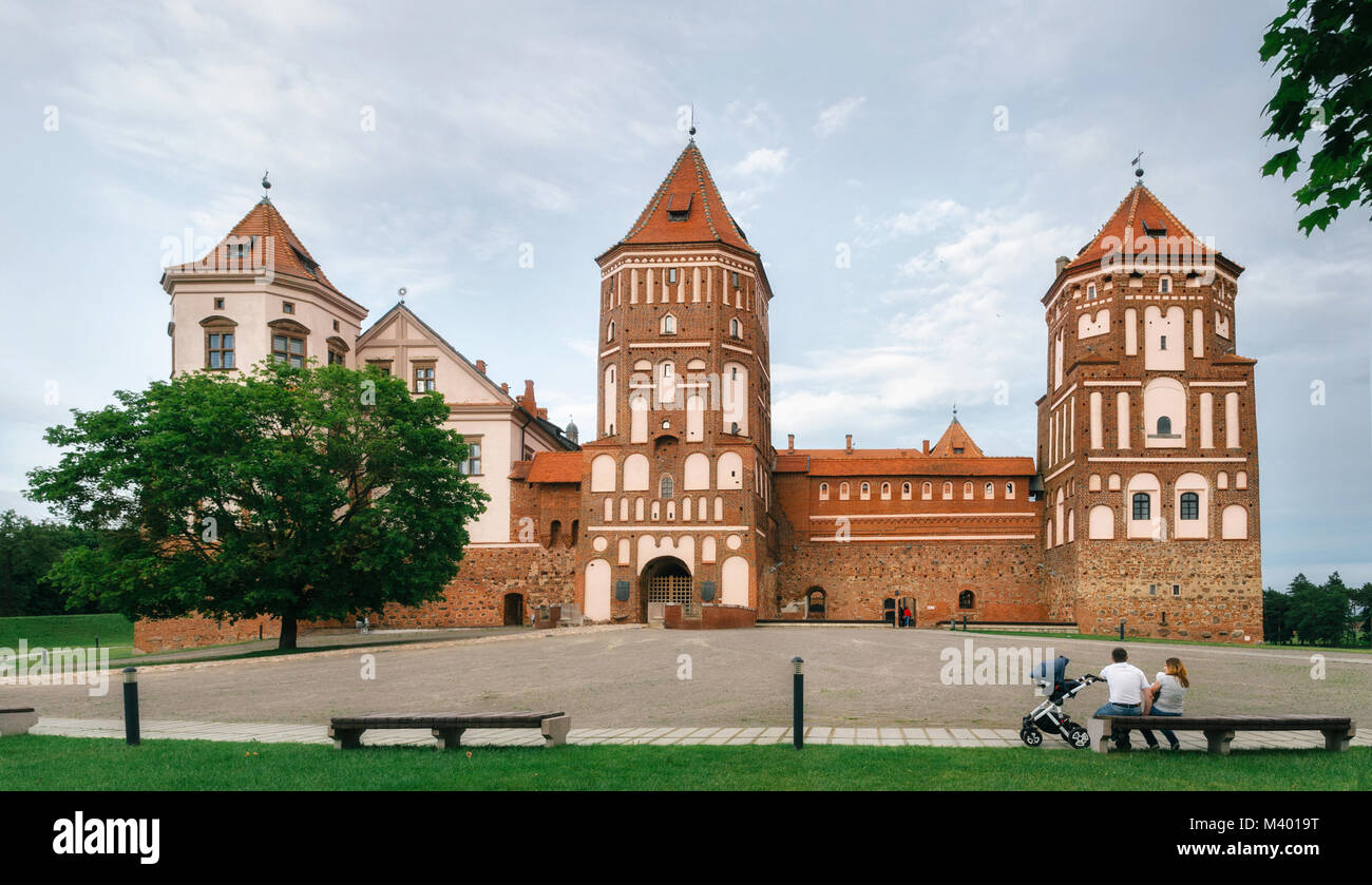Mir, Belarus - June 25, 2017: Young family with baby sits on bench and ...