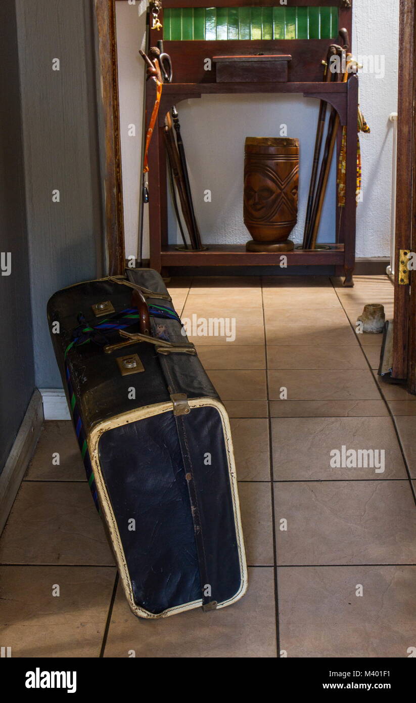 Dilapidated retro cardboard suitcase tied closed with a tie in front of ...