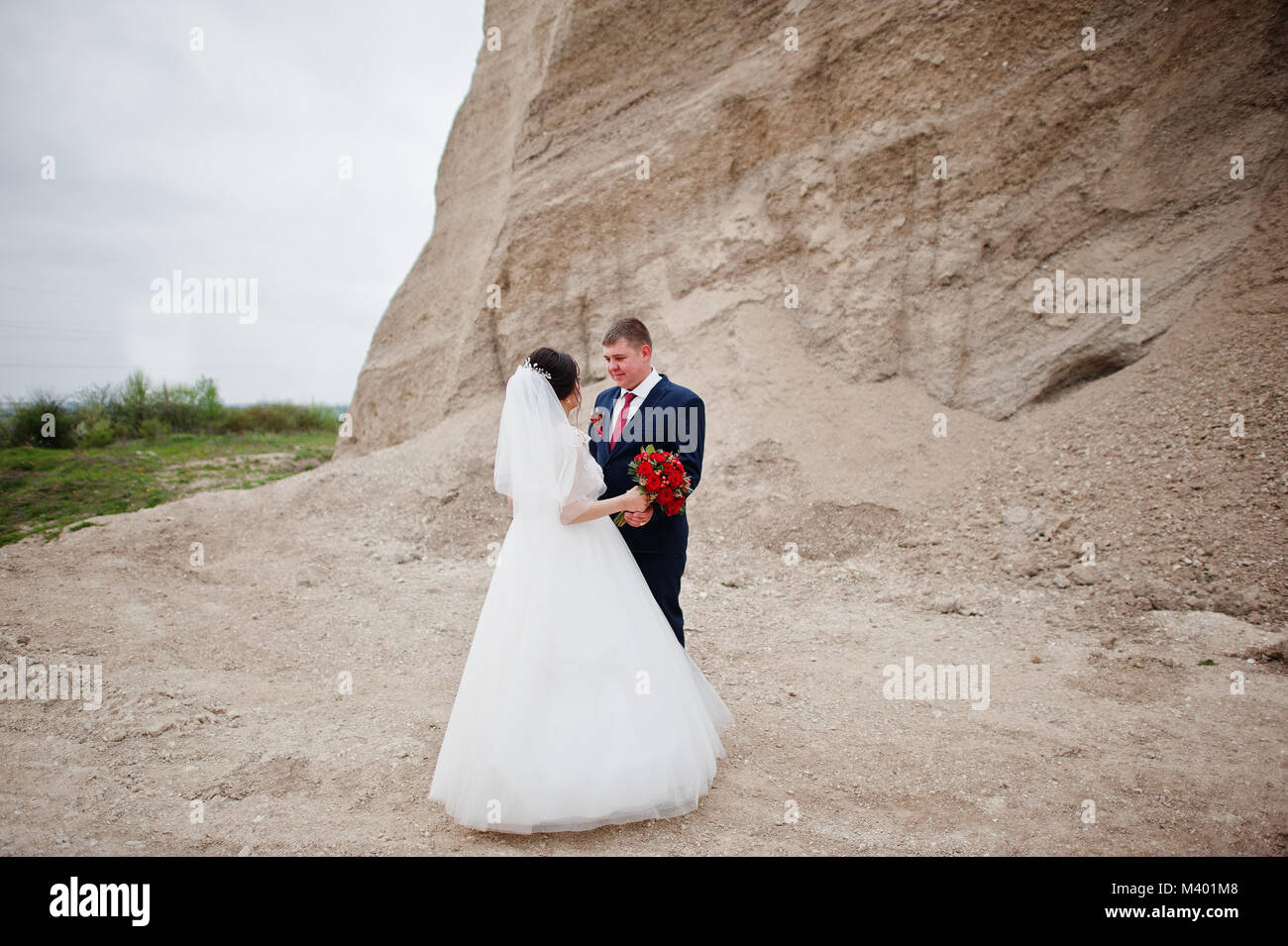 Young wedding couple posing in sand quarry on their wedding day Stock ...