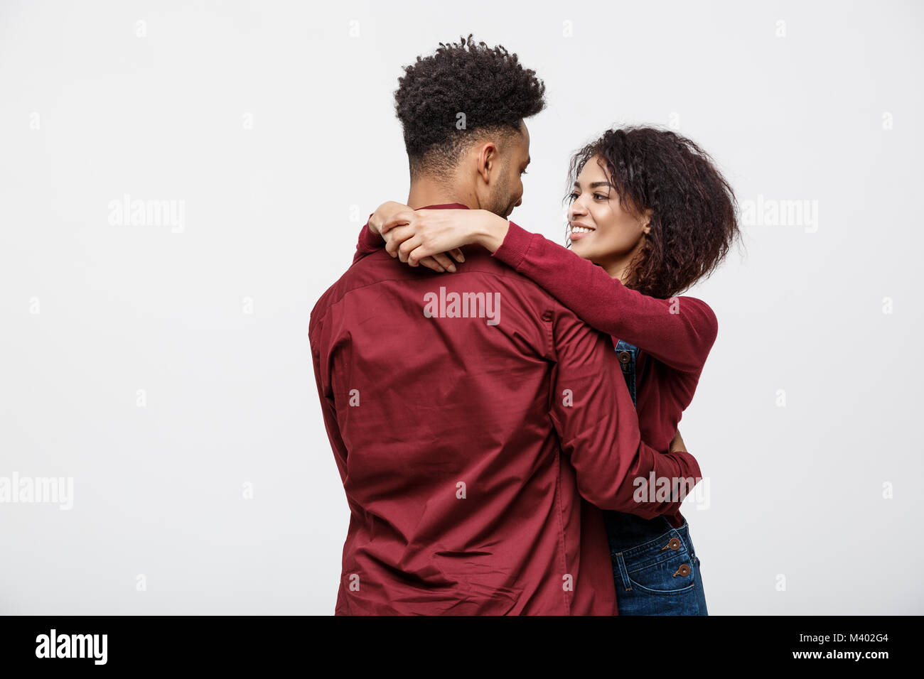 portrait of happy african american couple hug each other on white ...