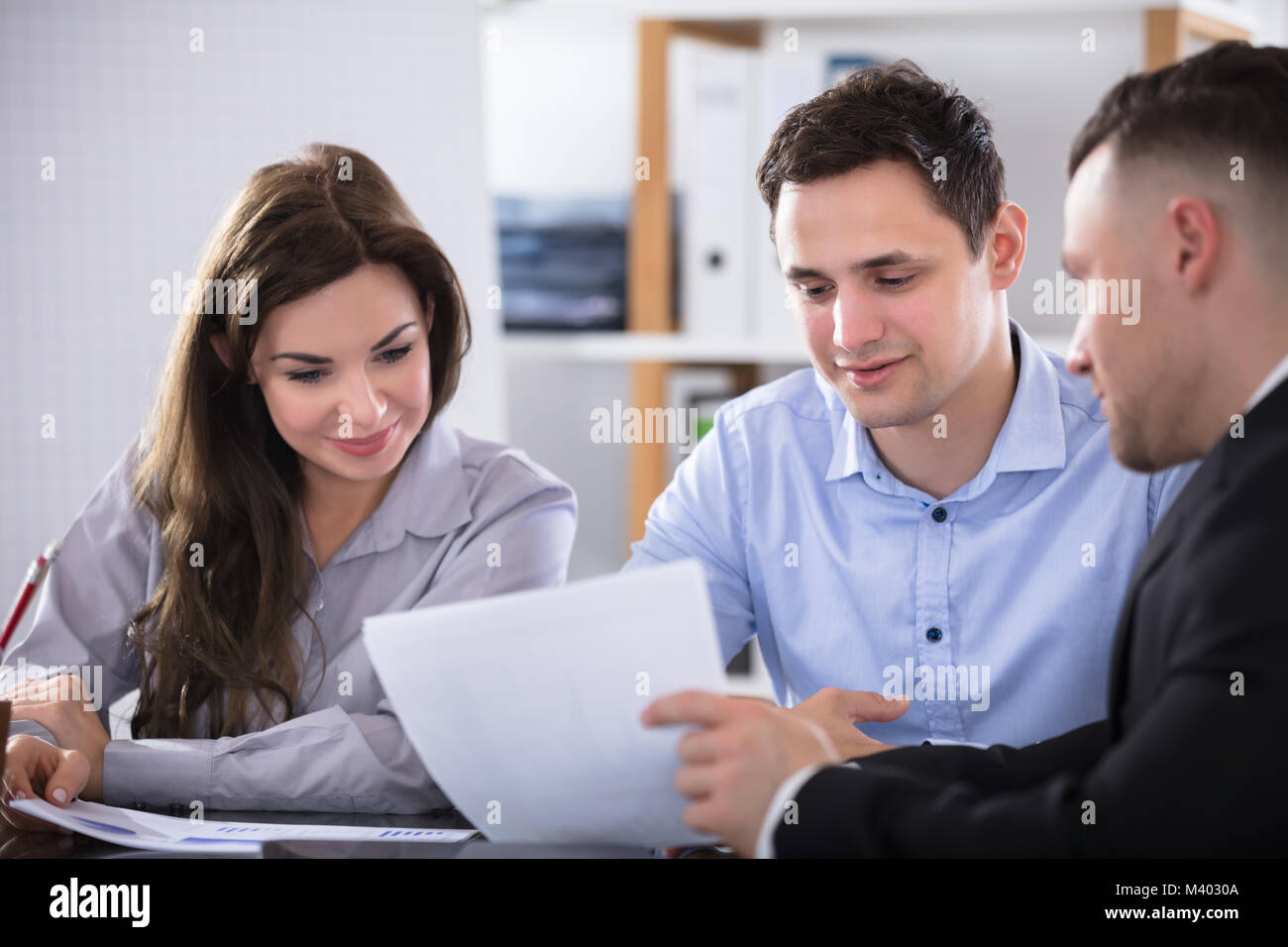 Couple Talking With Advisor During Meeting In Office Stock Photo - Alamy