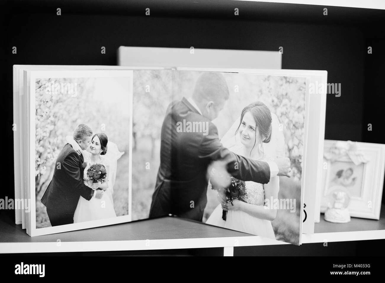 Pages of elegant photobook or wedding album on a small table Stock ...