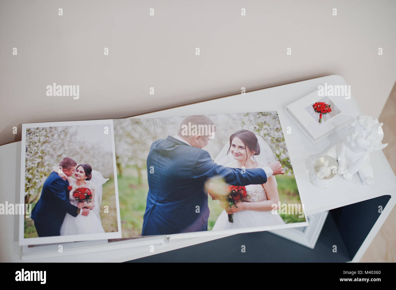 Pages of elegant photobook or wedding album on a small table Stock ...
