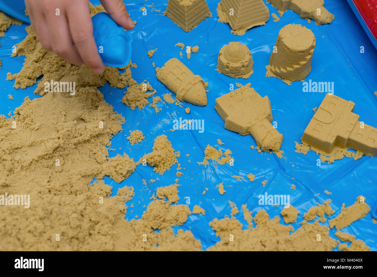 kid making different shapes by sand with moulds Stock Photo - Alamy