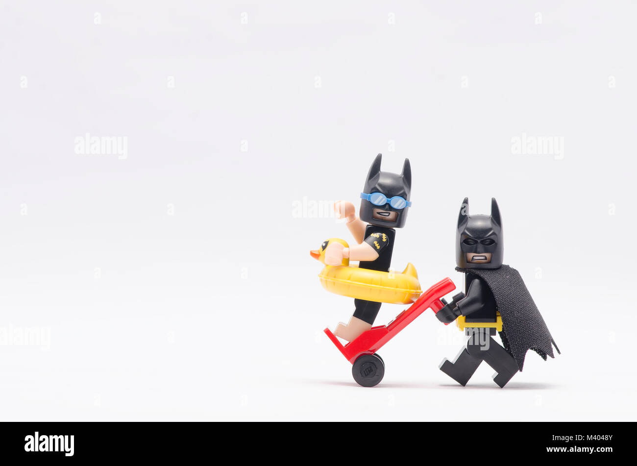 lego batman pushing trolley with vacation batman sitting on it ...