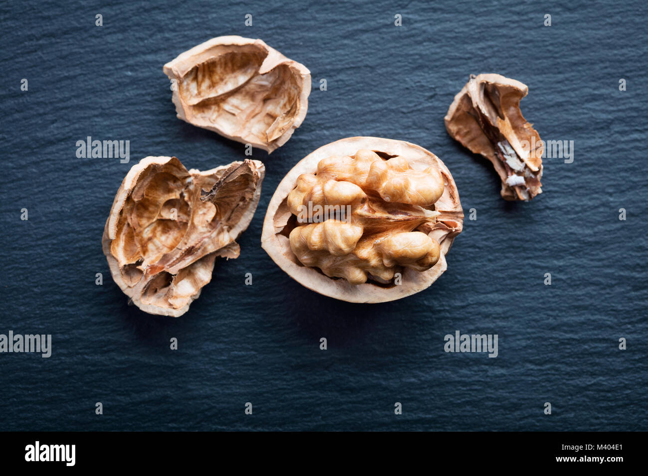 close-up view of cracked walnut on slate background Stock Photo - Alamy