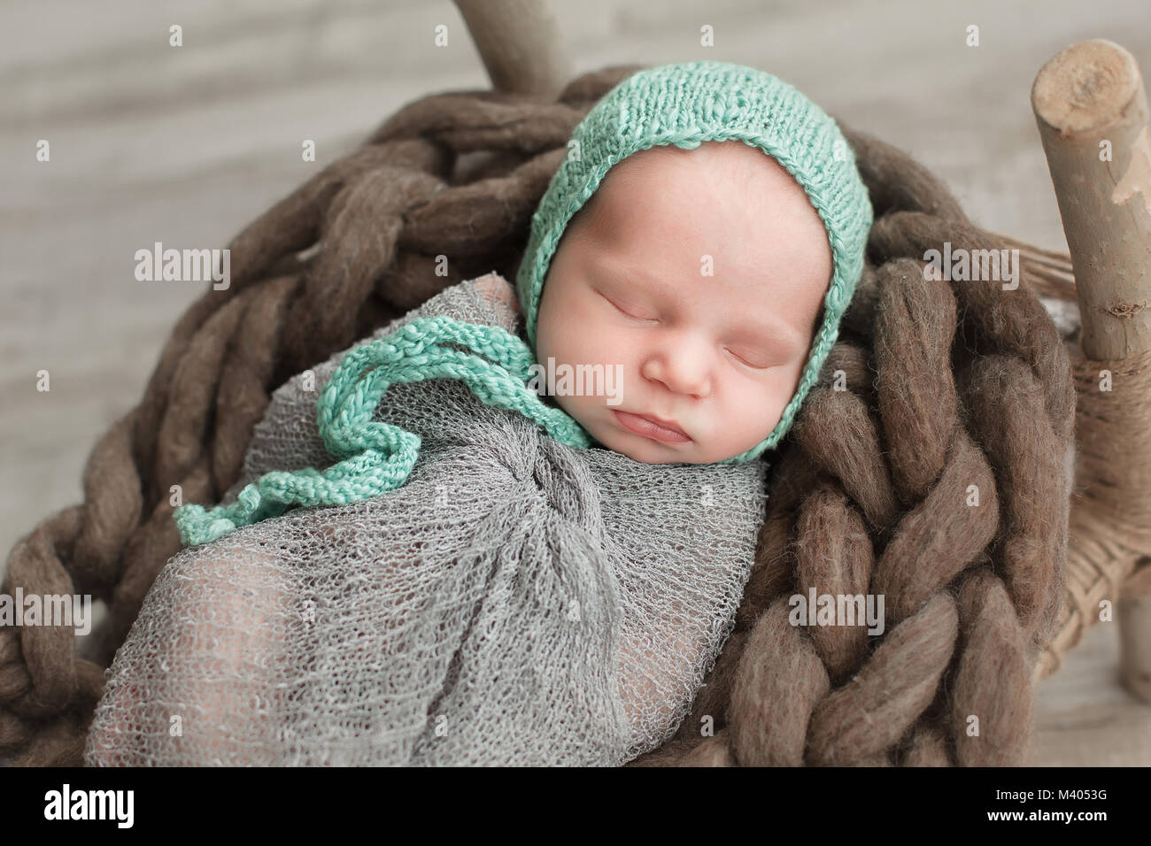 Sleeping newborn baby boy swaddled in a blanket Stock Photo - Alamy