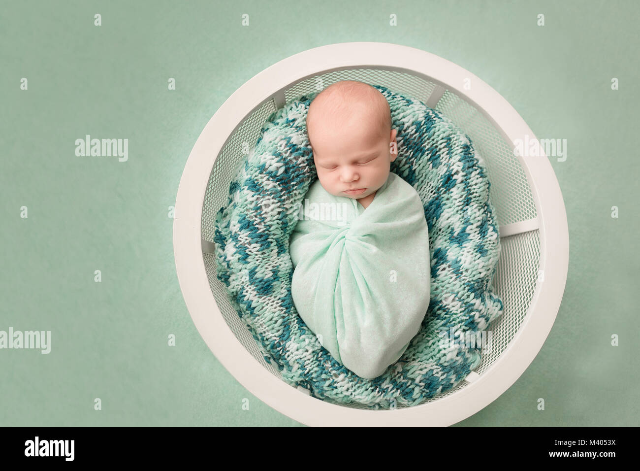 Sleeping newborn baby boy swaddled in a blanket Stock Photo - Alamy