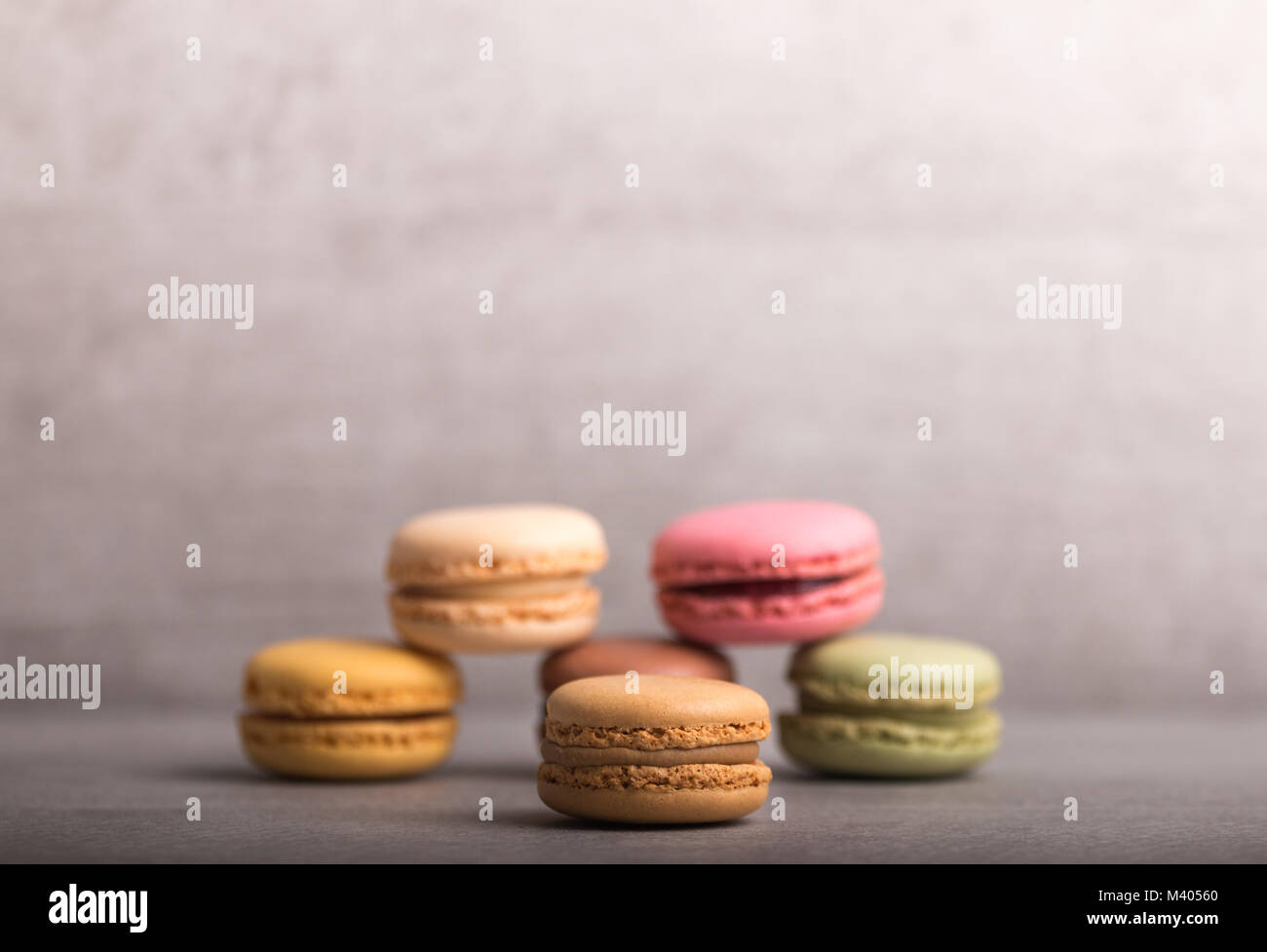 different tasteful macaroons on a light grey background front view ...