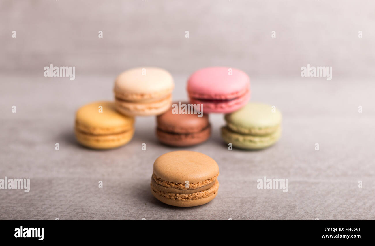 different tasteful macaroons on a light grey background top view Stock ...