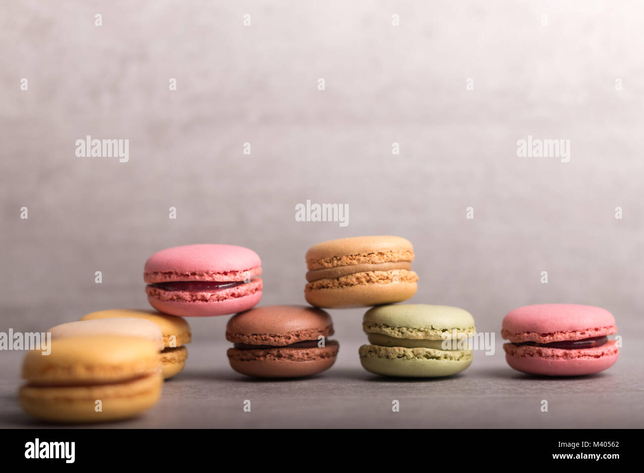 different tasteful macaroons on a light grey background Stock Photo - Alamy